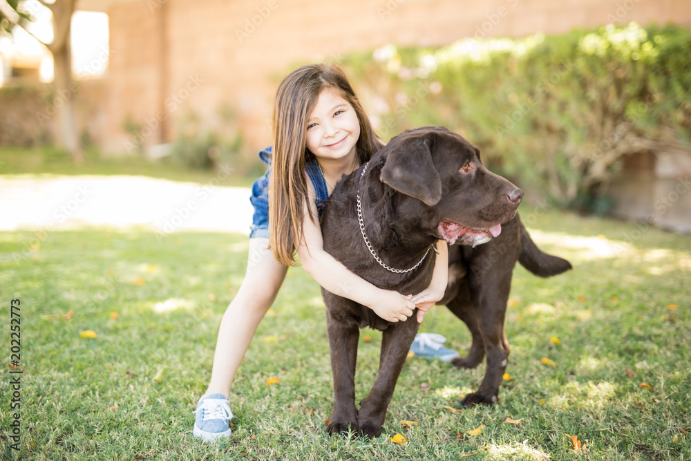 Girl embracing pet dog Stock Photo | Adobe Stock