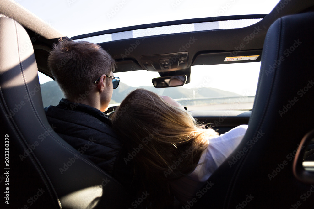 Romantic young couple in love drives car together to far destination ...