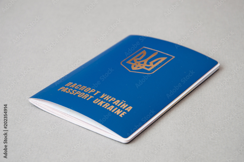 Foreign passport of Ukraine is isolated on a gray background with space ...