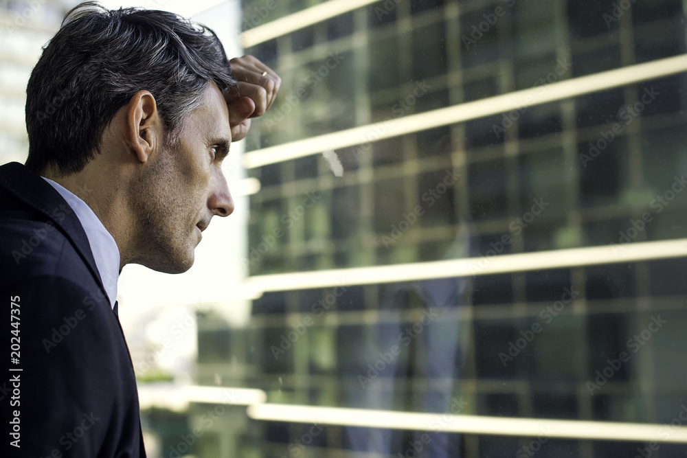 Man looking through window in high rise building Stock Photo | Adobe Stock