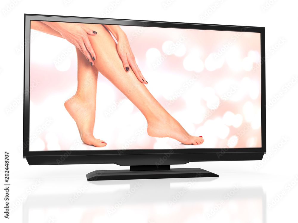 Female legs and hands with smooth skin on the screen of modern LED TV ...