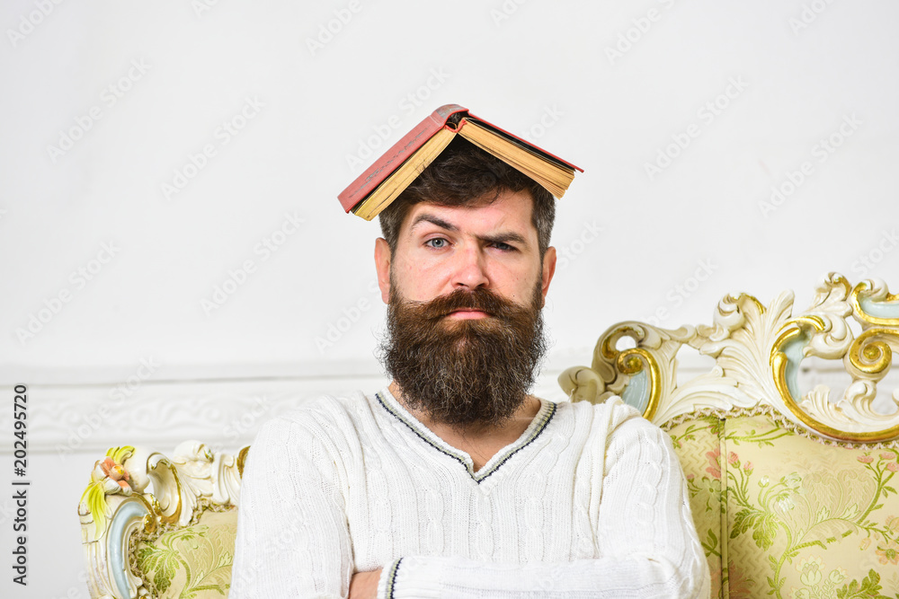 Macho sits with open book on head, like roof. Overwork concept. Guy ...