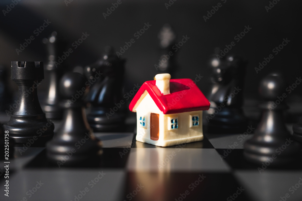 Miniature house on chess board background using as property concept ...