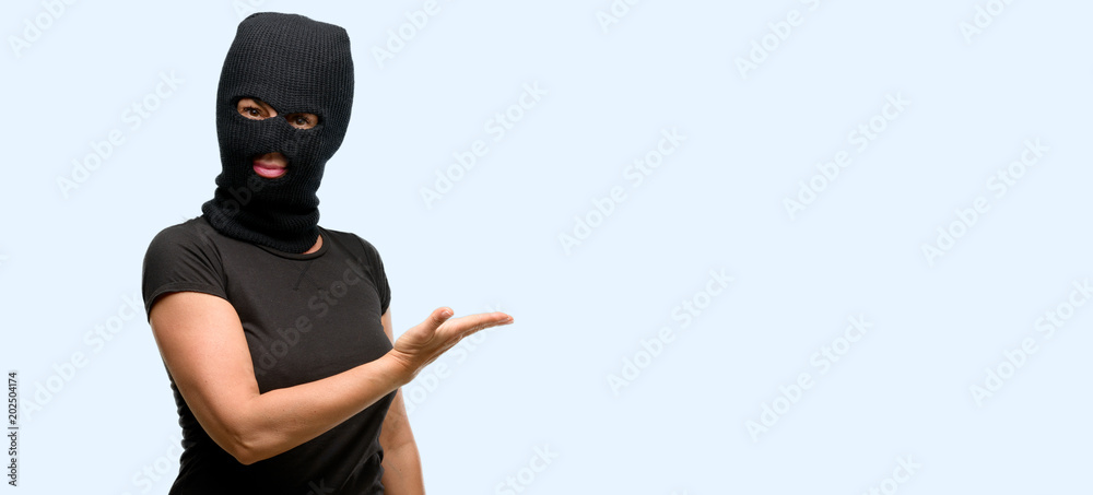 Burglar terrorist woman wearing balaclava ski mask holding something in ...