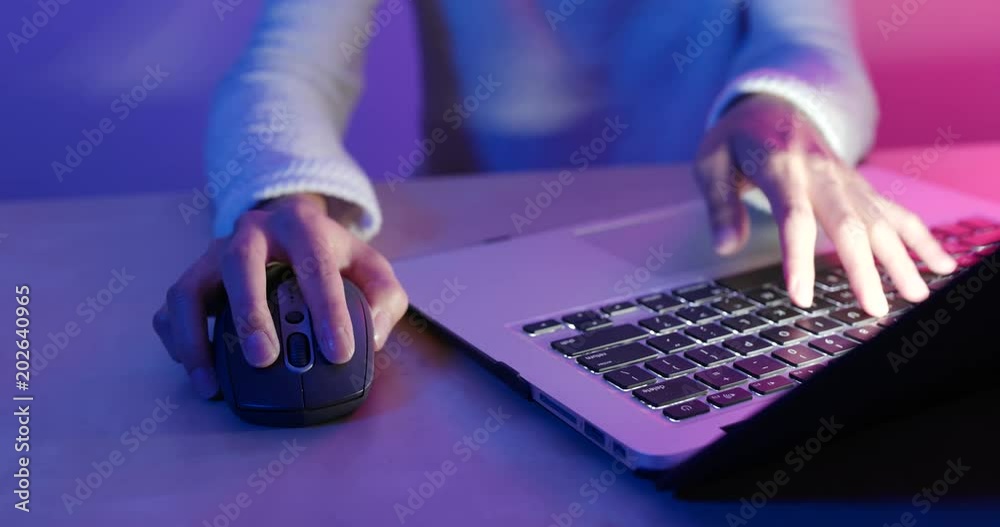 Woman playing game on computer under red and purple light Stock ビデオ ...