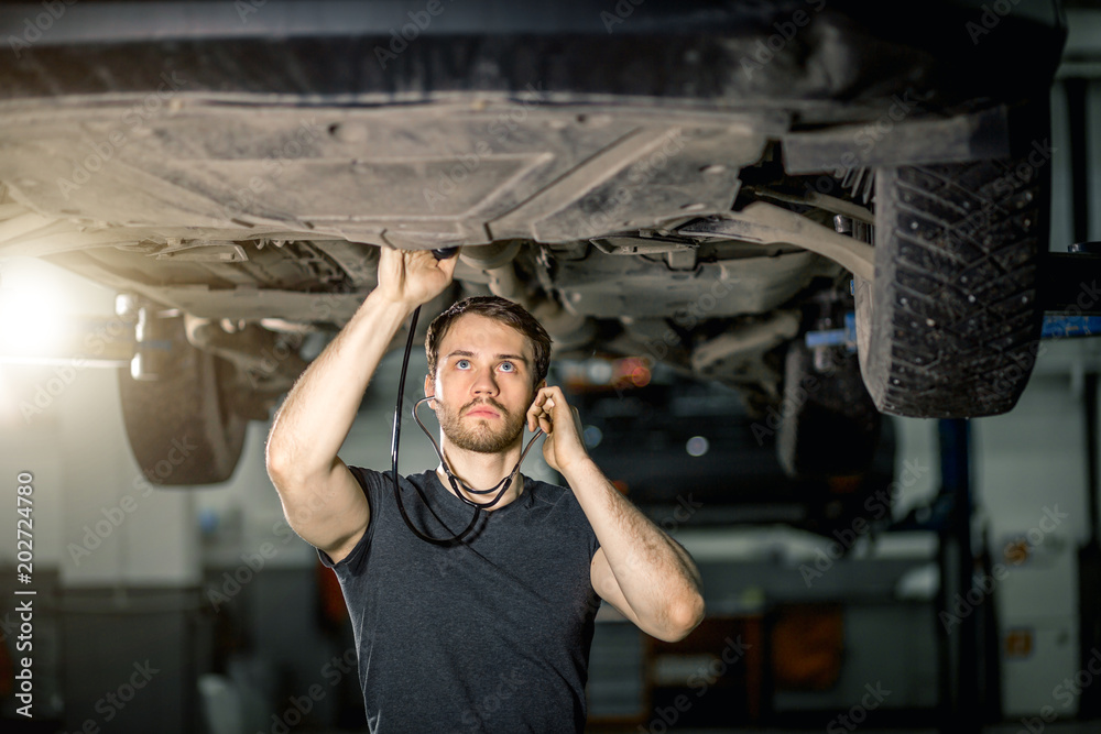 mechanic listen engine with stethoscope in repair garage Stock Photo ...