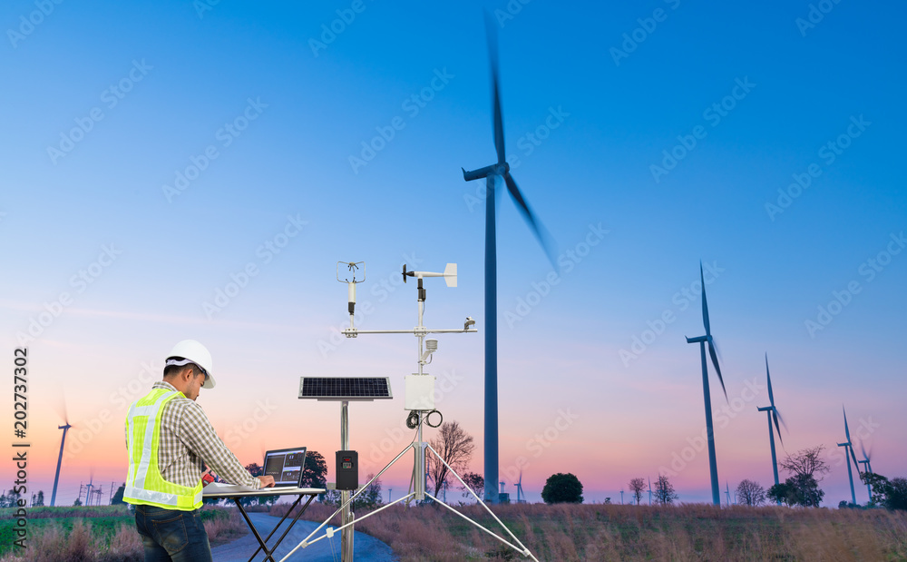 Engineer using laptop computer collect data with meteorological ...