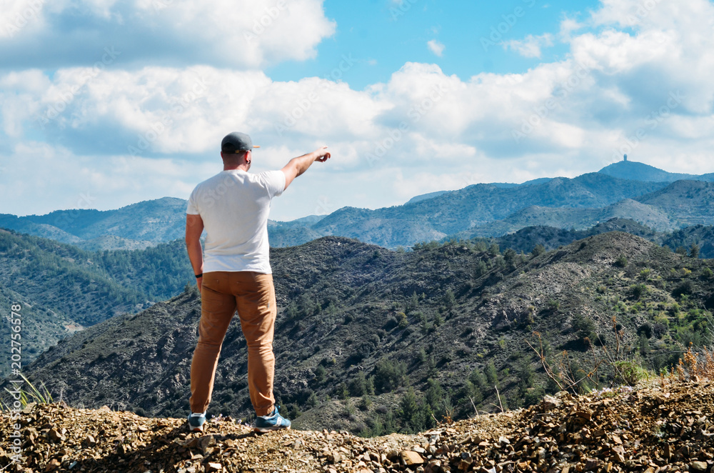Hiking man pointing on something with his hand, point finger. Man show ...
