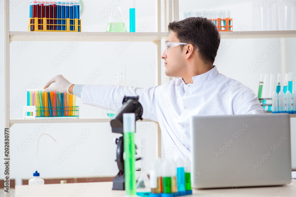 Man student working in chemical lab on experiment Stock Photo | Adobe Stock