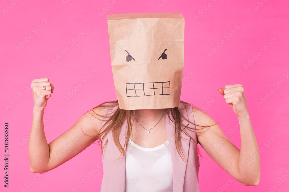 Concept of negative emotions - Angry woman with a paper bag on his face ...
