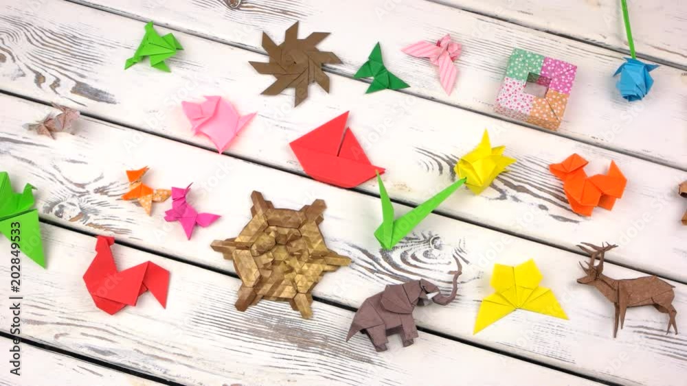 Set of origami objects on rustic wooden background. Collection of ...