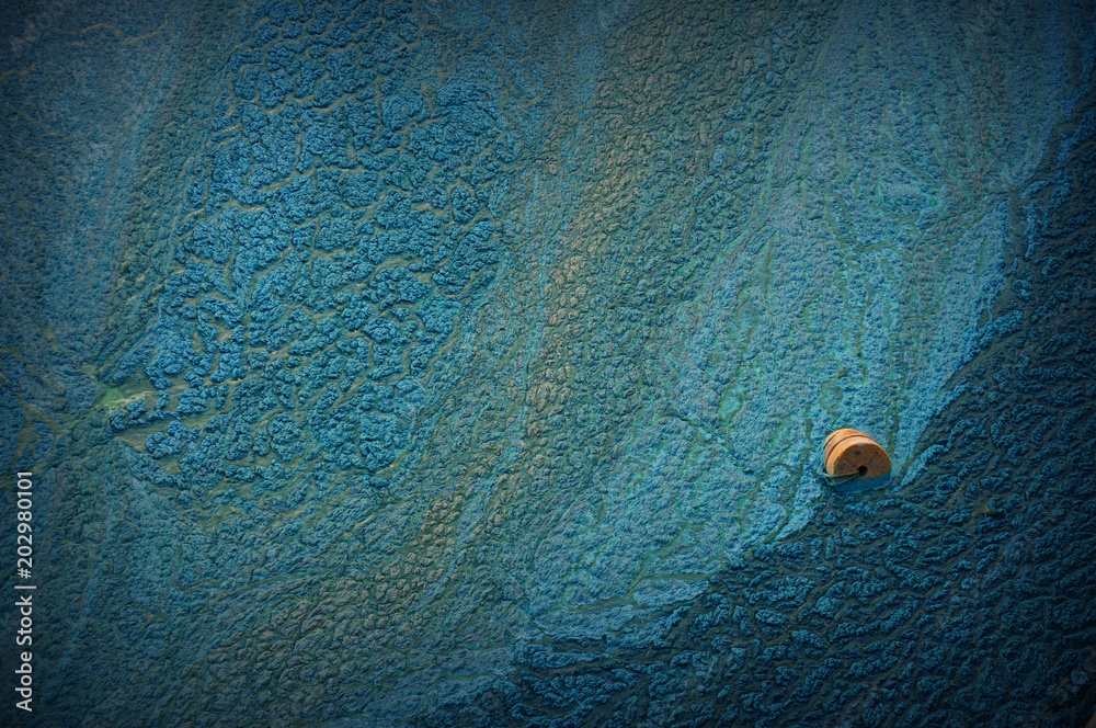 Yellow buoy in the blue sludge ocean . Sludge texture. Blue background ...
