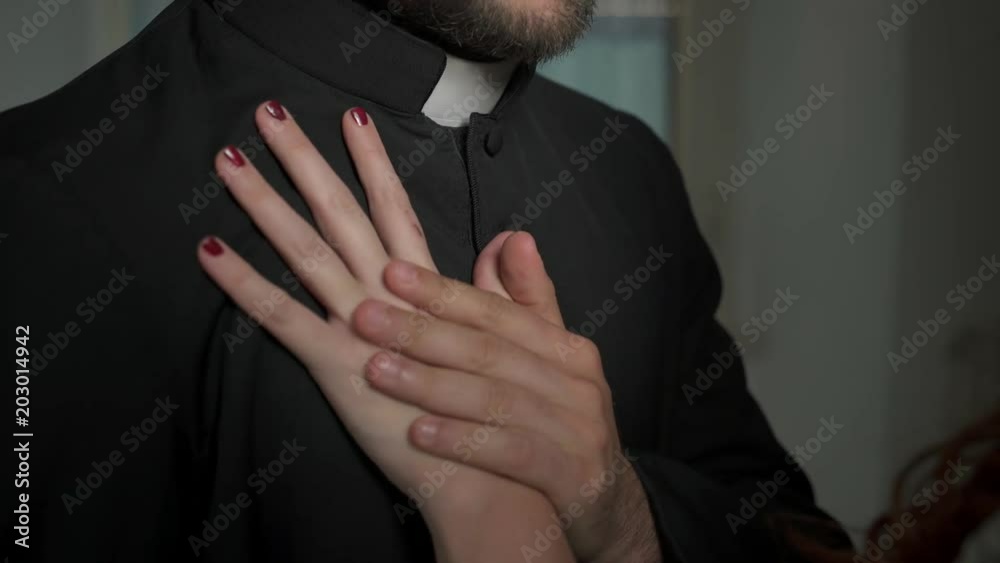 the temptation of sex for a priest: a woman seduces a priest Stock ...