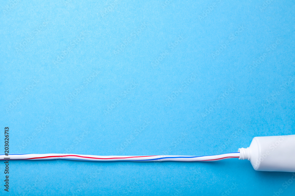 Colored toothpaste squeezed out line from tube on blue background Stock ...