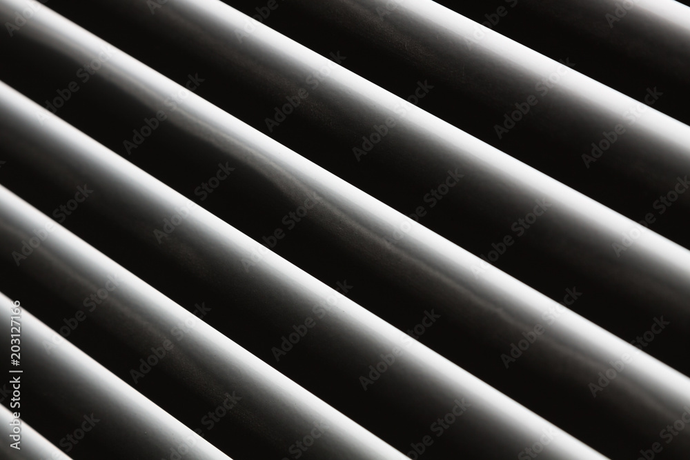 An abstract snapshot of a close-up illuminated grille that is angled ...