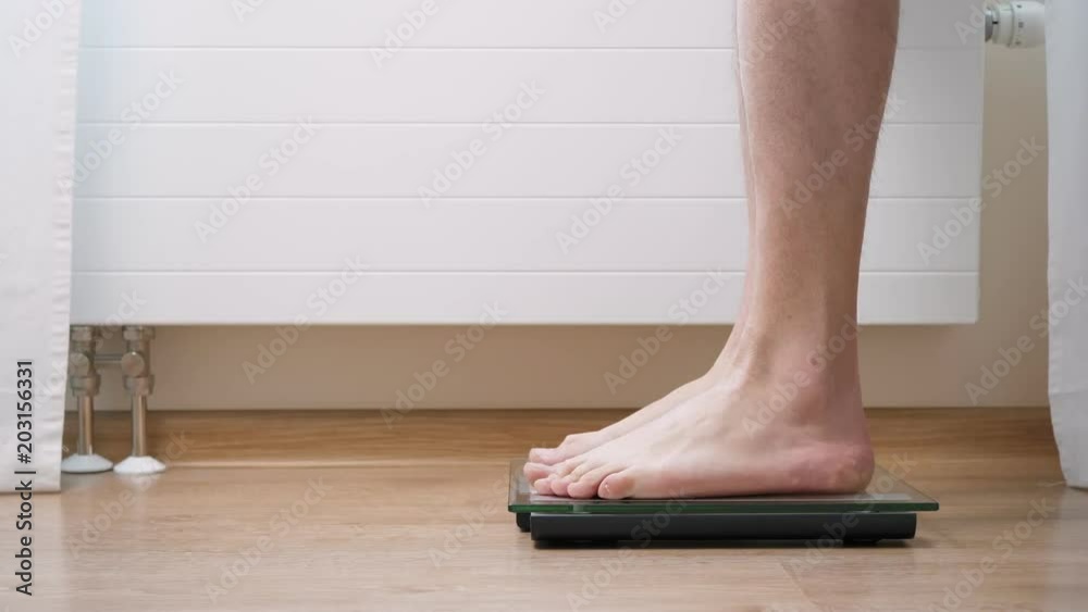 Man step on digital glass scales to check his weight Stock Video ...