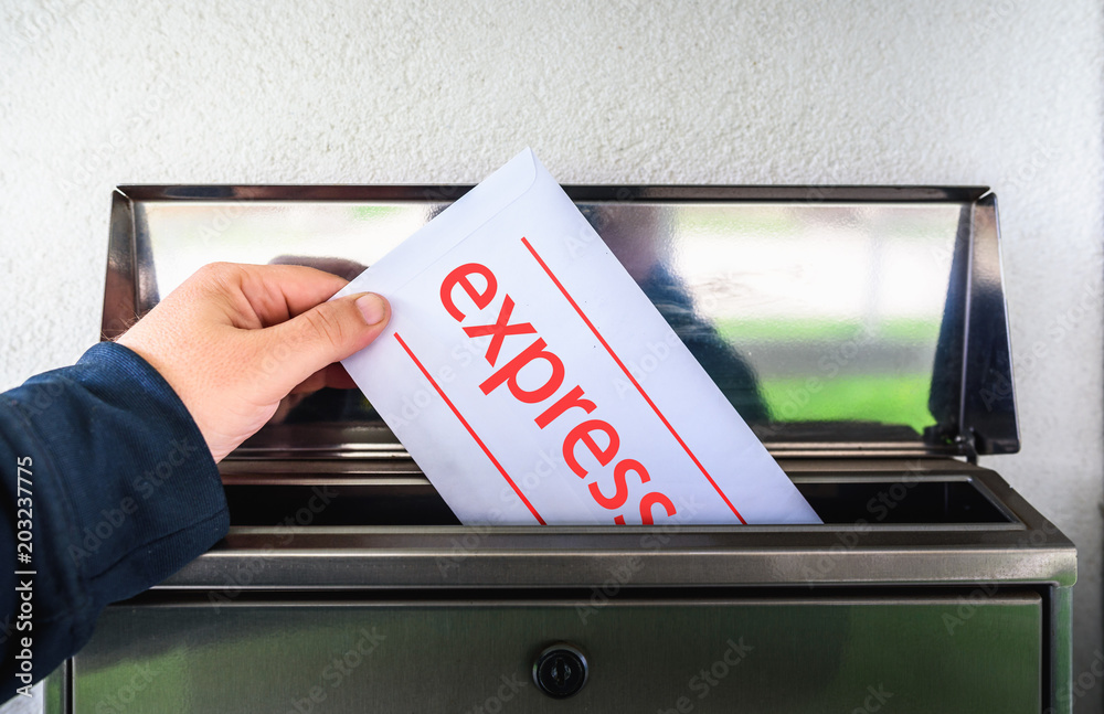 express mail delivery . Hand putting letter with word express in ...