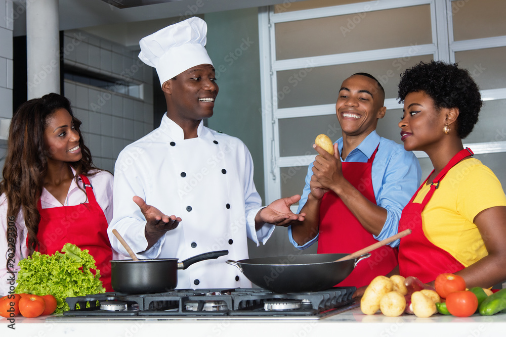 African american chef teaching women and men at kitchen Stock Photo ...
