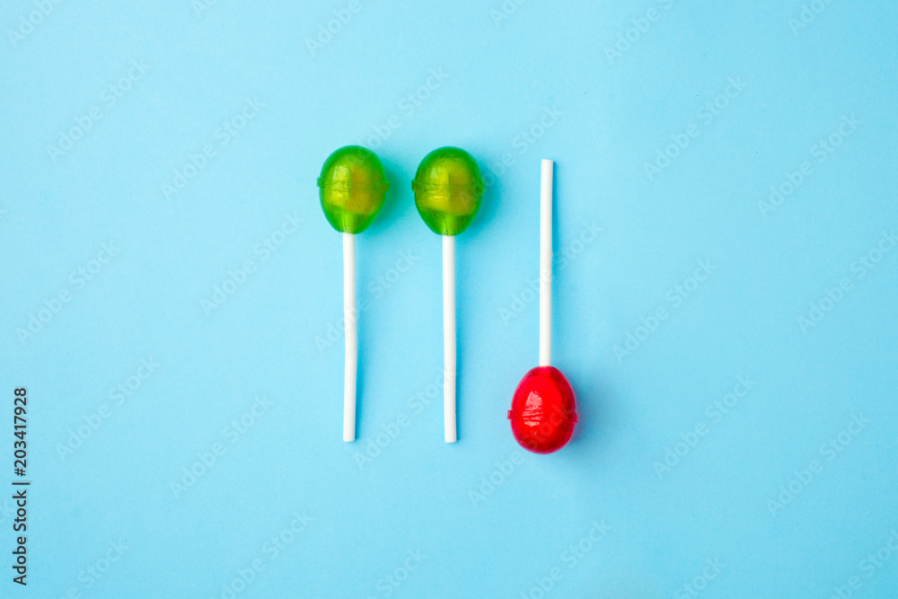 Lollipop flat lay minimal concept, three round lollipops are luing on ...