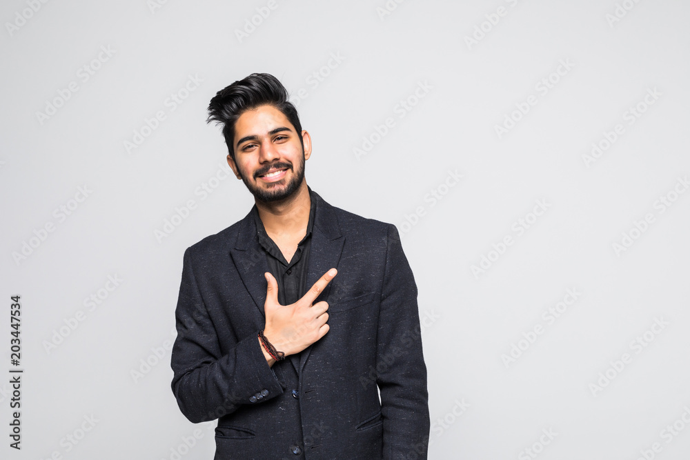 Young indian man pointing at something interesting on a white ...