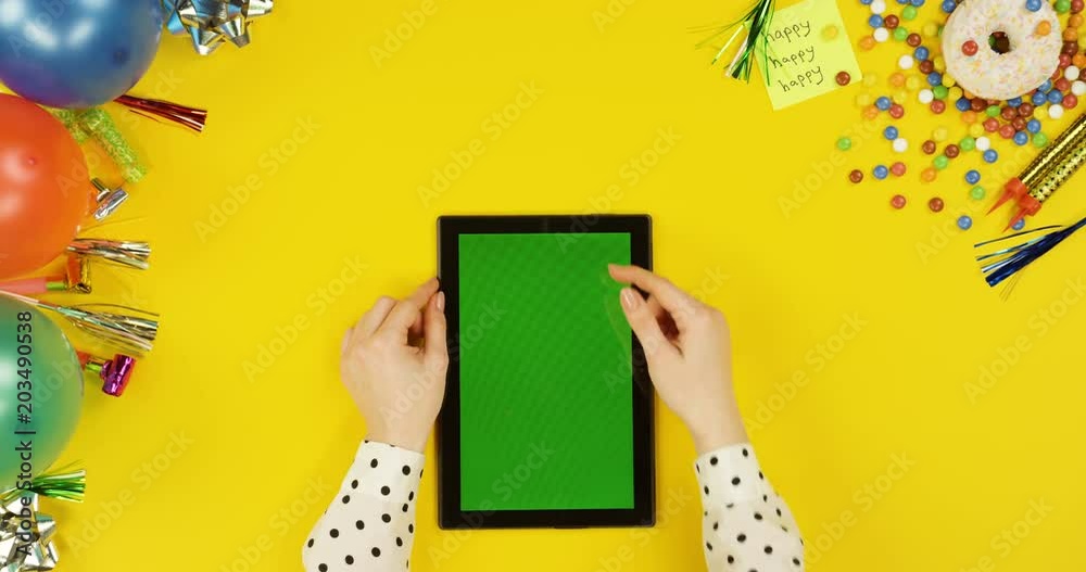 View from above on the black tablet device on the yellow table with ...