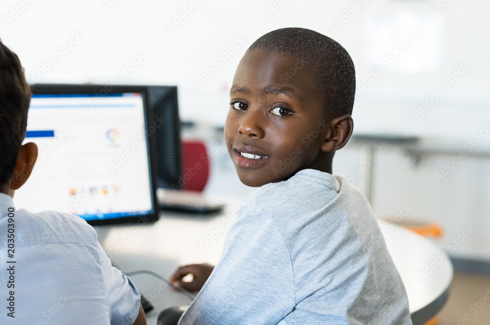 African boy using computer at school Stock Photo | Adobe Stock