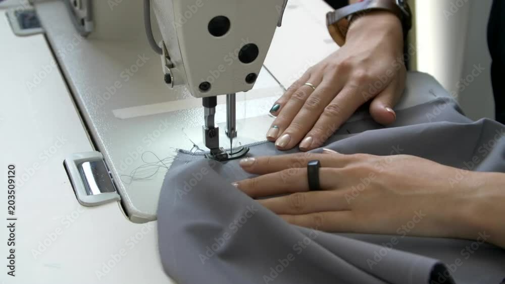 The tailor makes a seam on the pants on the sewing machine Stock Video ...