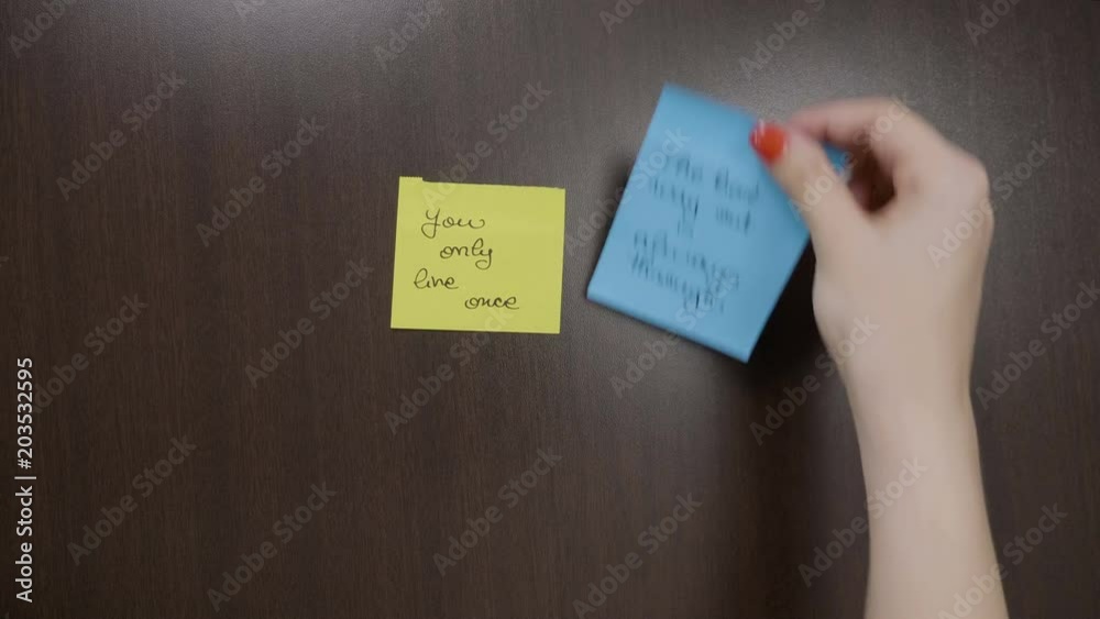Young depressed woman sticking handwritten post it with motivational ...