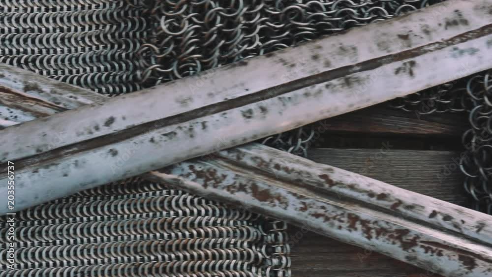 Crossed swords on chain armor, close up, historical ancient weapon ...