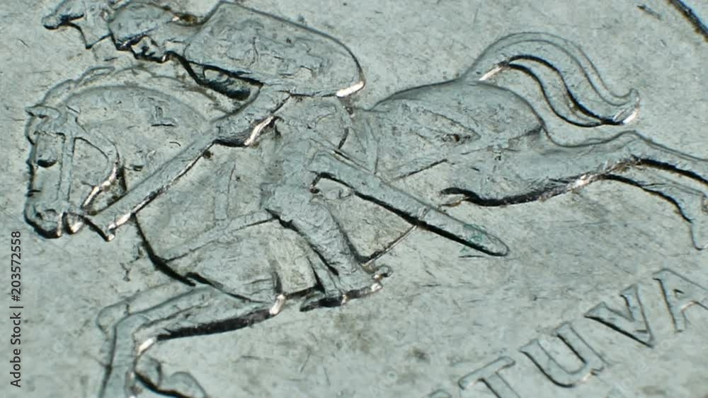 National symbols of Lithuania on the metal coin. The heraldic shield ...