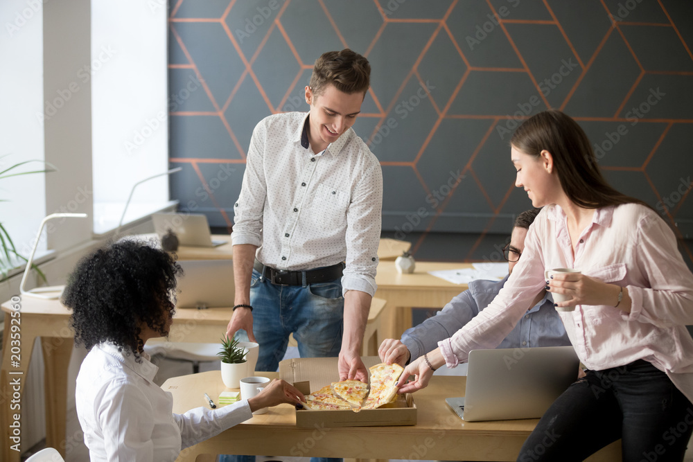 Friendly diverse team people eating pizza in office on lunch time ...