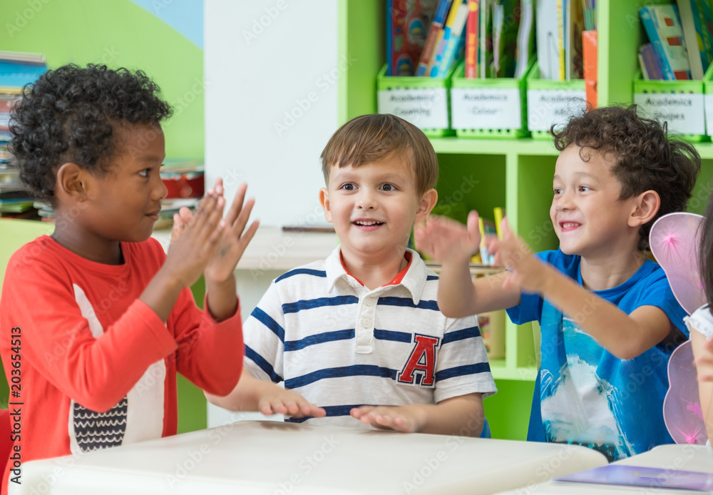 Group of diversity kids boy sit on table and playing together in ...