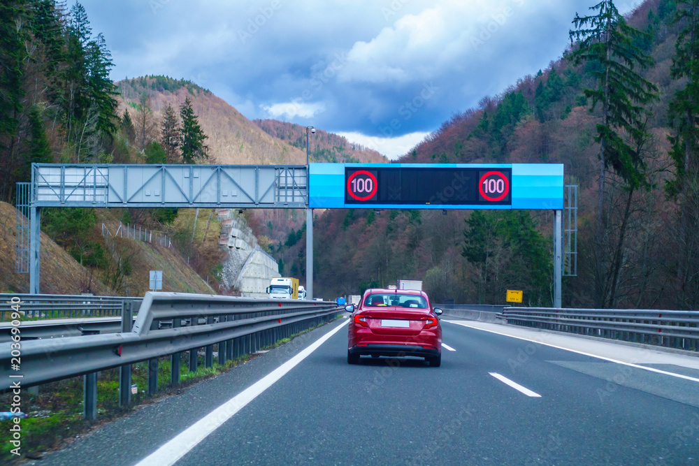 Modern LED traffic signs on highway, red car, truck on road Stock Photo ...