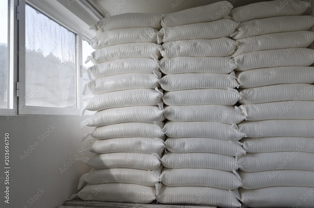 Three piles of big sacks at warehouse in modern factory Stock Photo ...