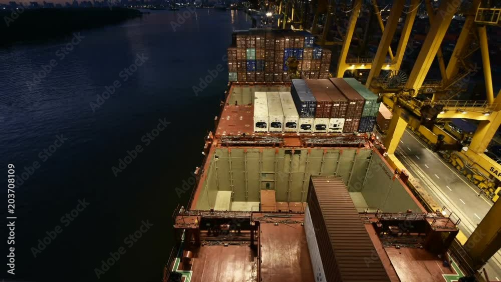 Container Cargo freight ship with working crane loading bridge in ...