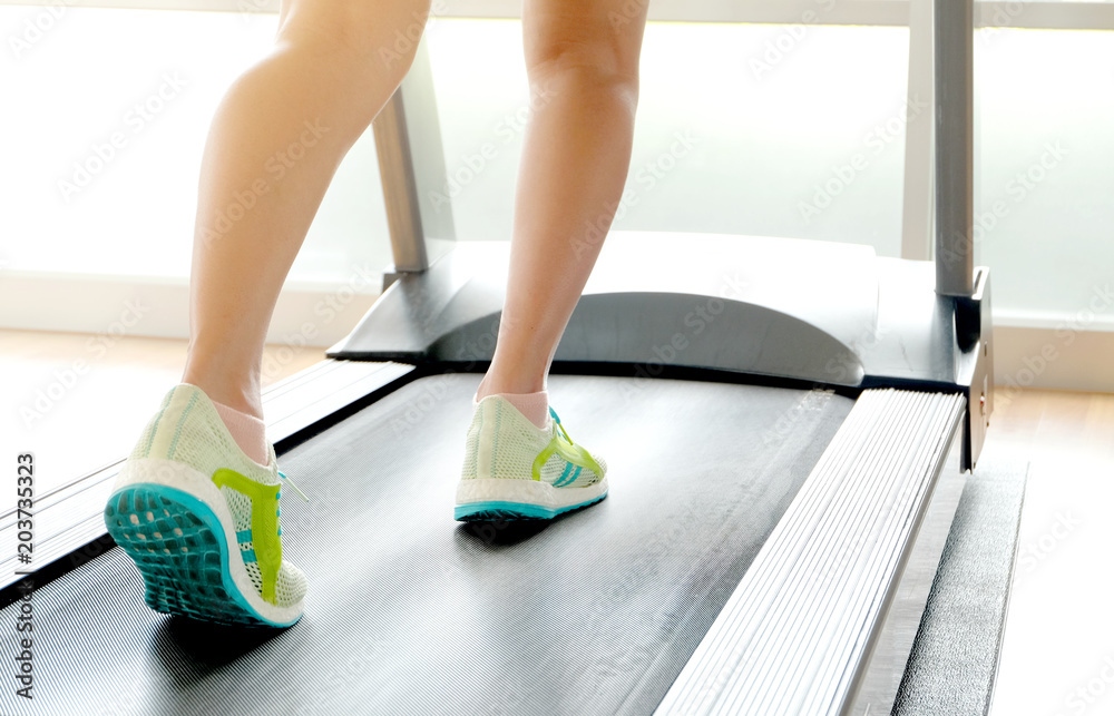 leg of woman running on treadmill in the gym which runner athletic by ...