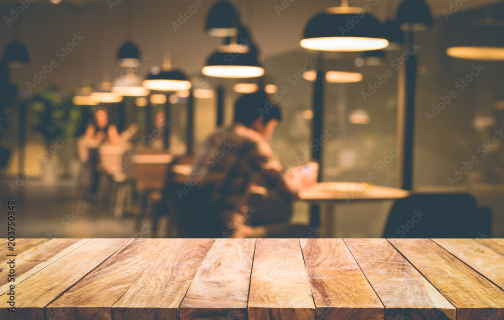 Wood table top with blur of people in coffee shop or (cafe,restaurant ...