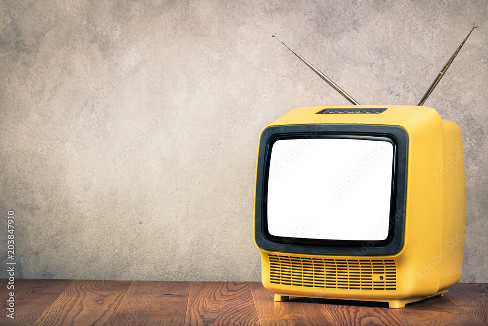 Retro old outdated yellow TV receiver from circa 60s on wooden table ...