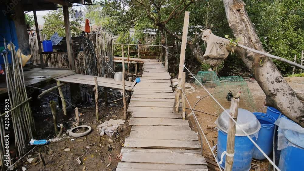 Houses of the poor in the Filipino slums. The swamp. Wooden bridges ...