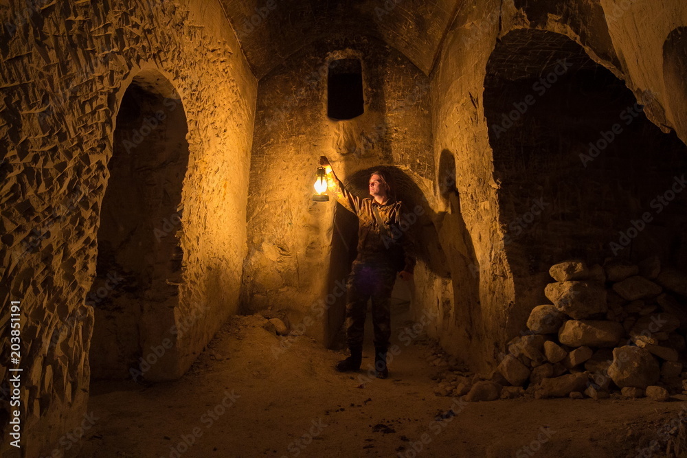 Man with kerosene lamp explores ancient abandoned underground chalky ...