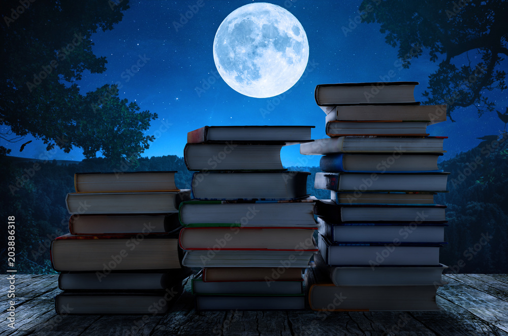 Knowledge concept. Stack of books on a night background. Stock ...