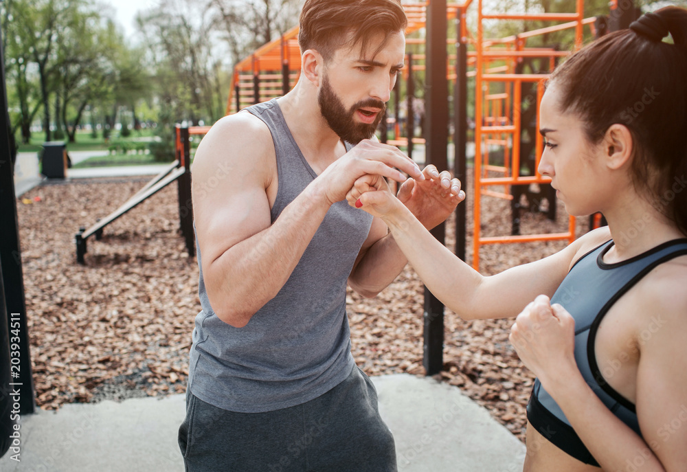 Two young people are fighting with each other. Girl is attacking boy ...