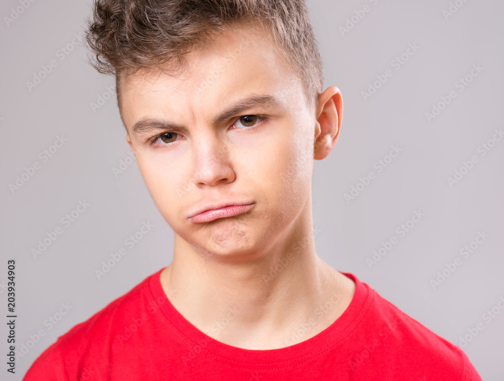 Emotional portrait of caucasian upset problem teen boy. Sad boy looking ...
