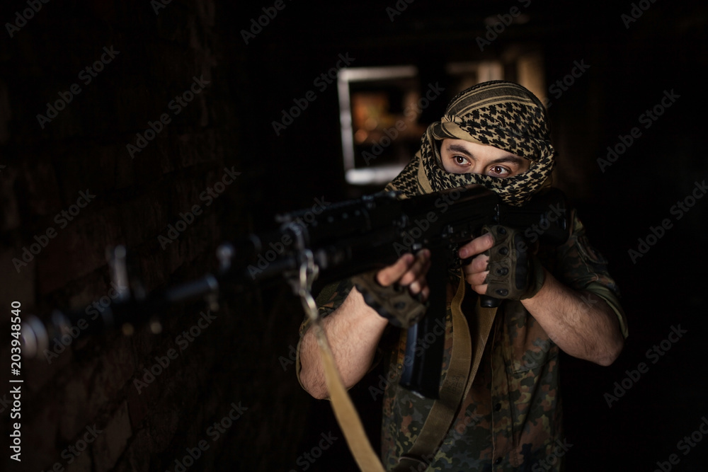 Foto de Arab soldier aiming with Kalashnikov AK-47 assault rifle do ...
