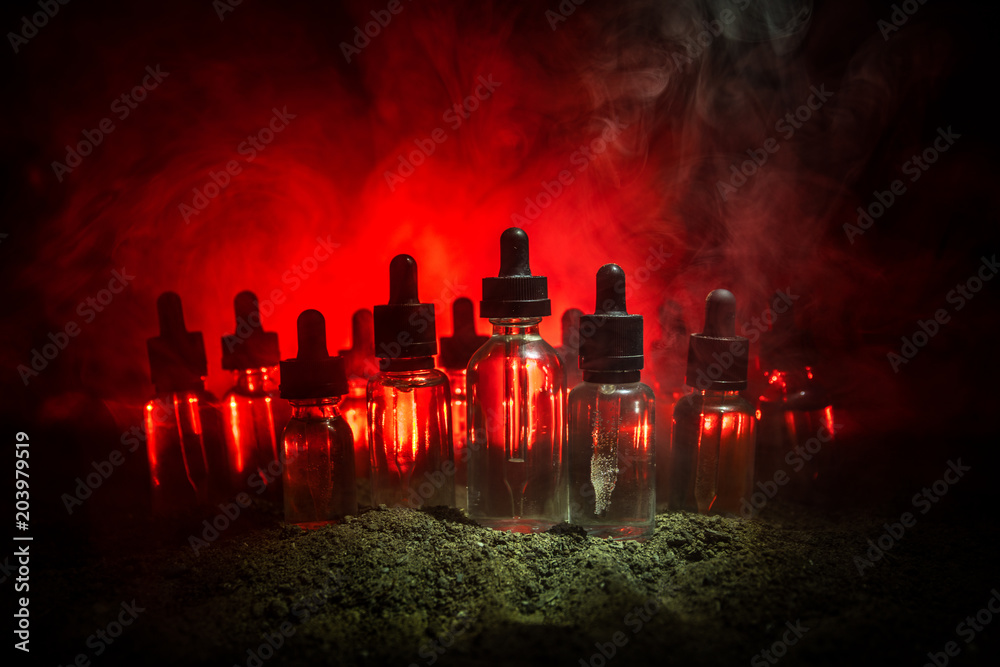 Vape concept. Smoke clouds and vape liquid bottles on dark background ...