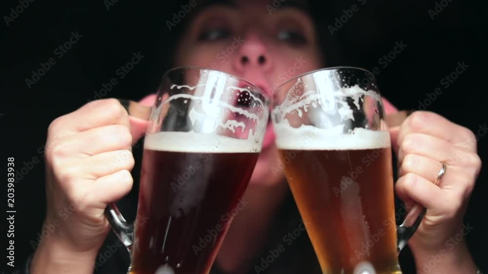 Woman acting silly celebrating with draft beers toasting herself ...