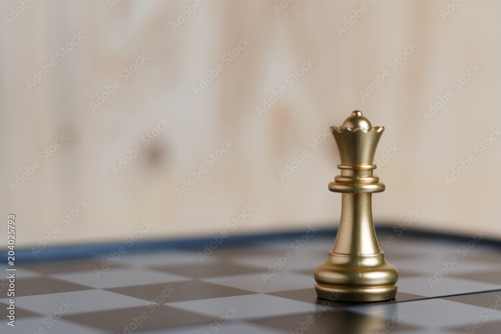 The gold queen chess set on board is located Stock Photo | Adobe Stock