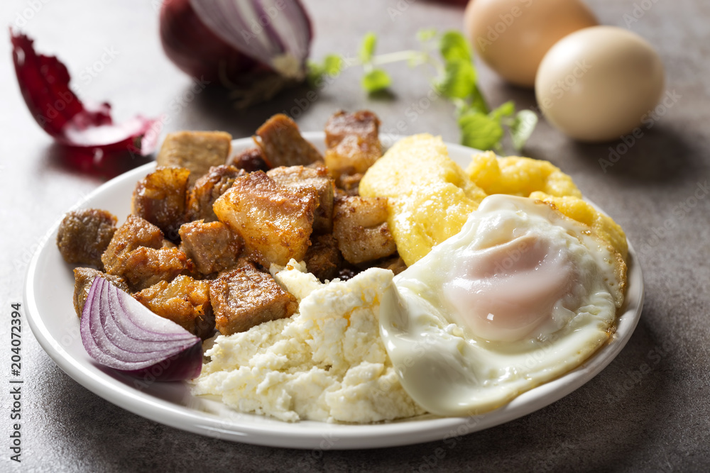 Traditional Romanian food "Tochitura Moldoveneasca" made with pork meat ...