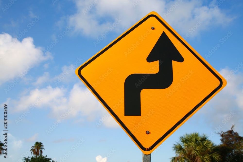 Yellow Curve in Road Sign with Black Curvy Arrow Frame Left with Palm ...