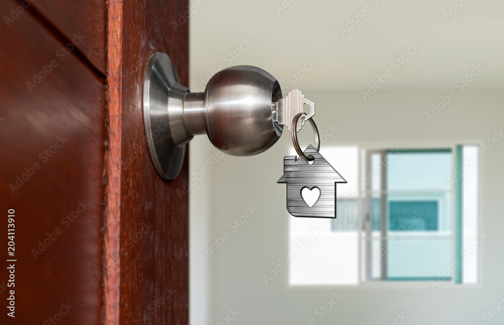 Open door with keys, House key in keyhole with small house Stock Photo ...
